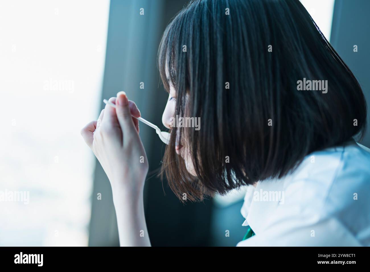 Female student eating soft ice cream Stock Photo - Alamy