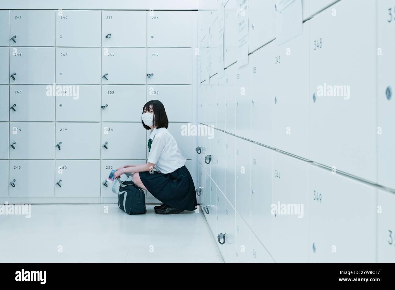 Female students standing in locker room Stock Photo - Alamy