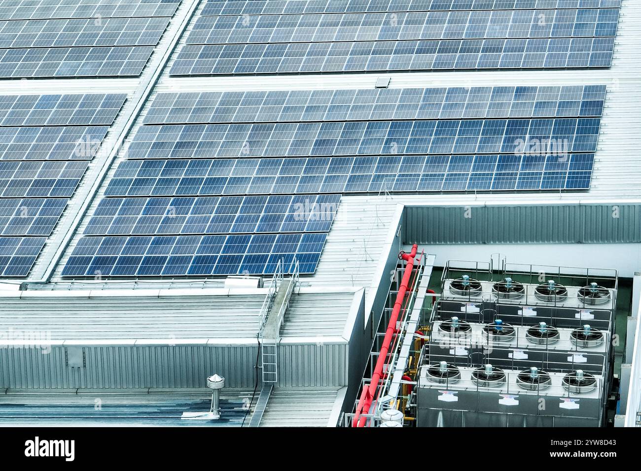 Solar energy for factory and warehouse building. Solar panels on roof of industrial plant ...