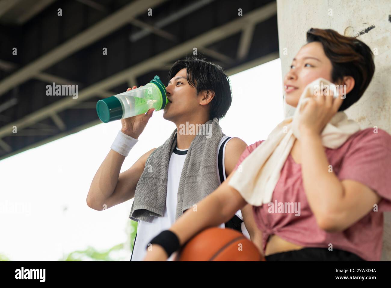 Men and women taking a break during basketball practice Stock Photo - Alamy