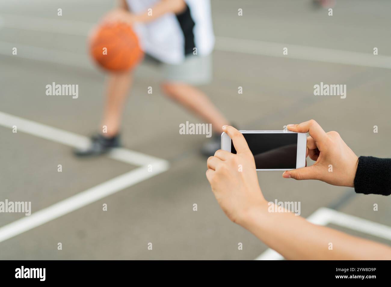 Woman recording basketball practice Stock Photo - Alamy
