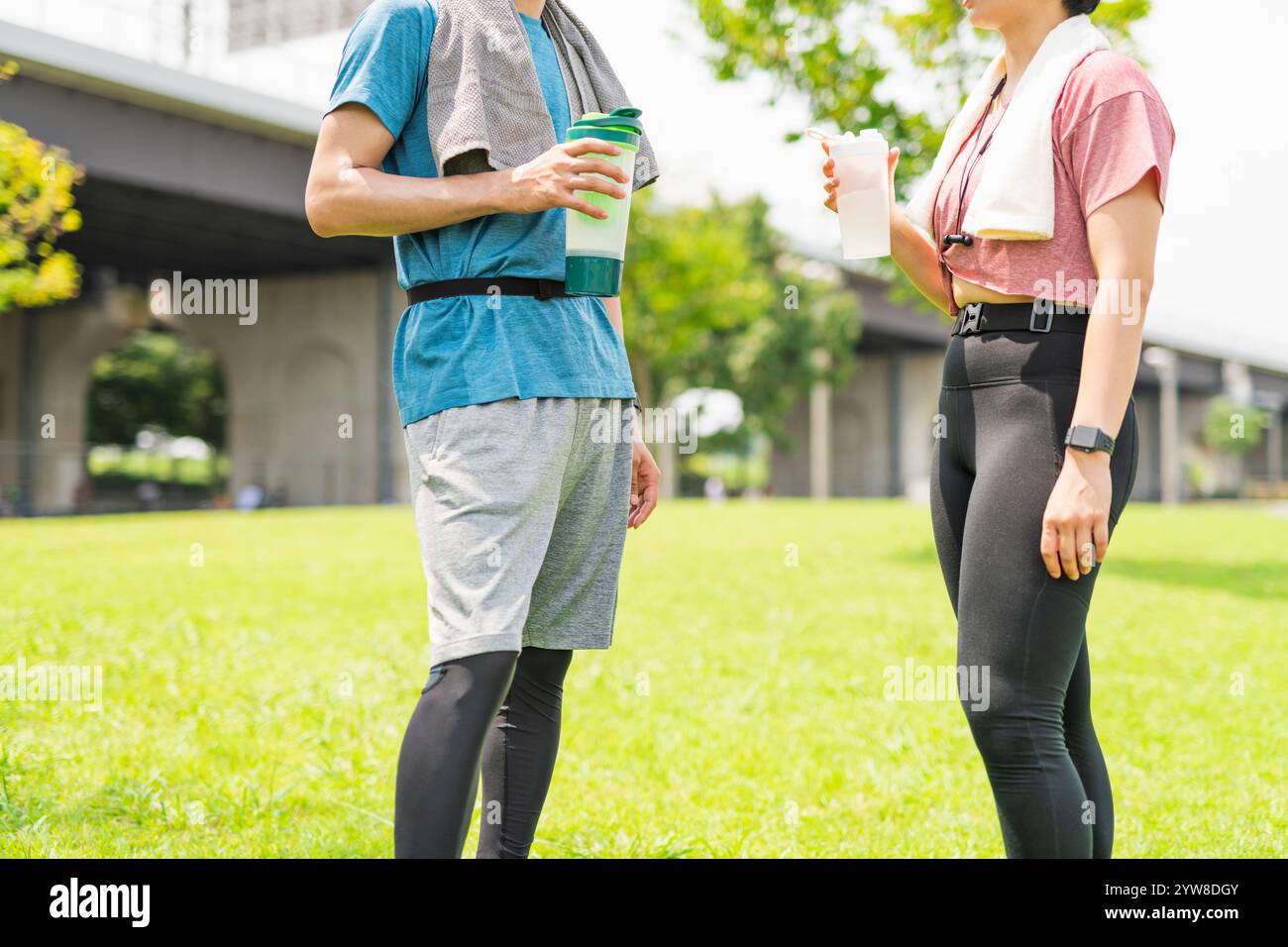 Men and women taking a break during exercise Stock Photo - Alamy
