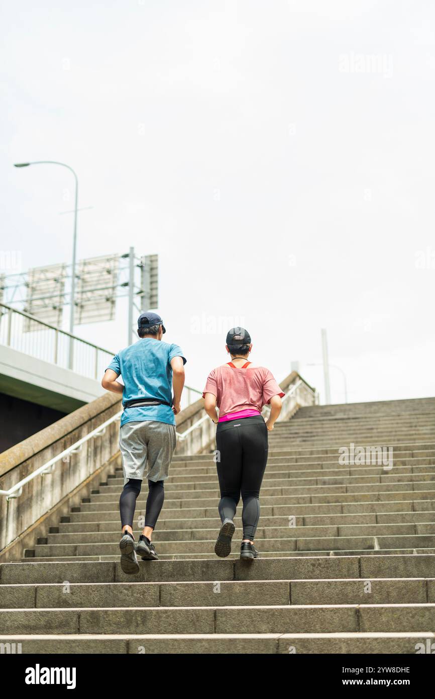 Two women running up stairs hi-res stock photography and images - Alamy