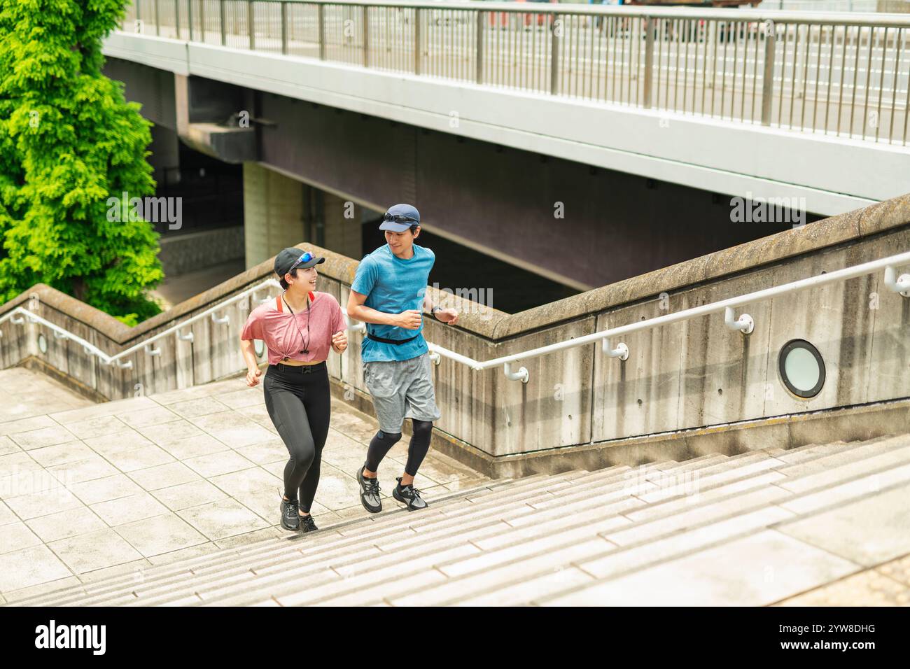 Two women running up stairs hi-res stock photography and images - Alamy