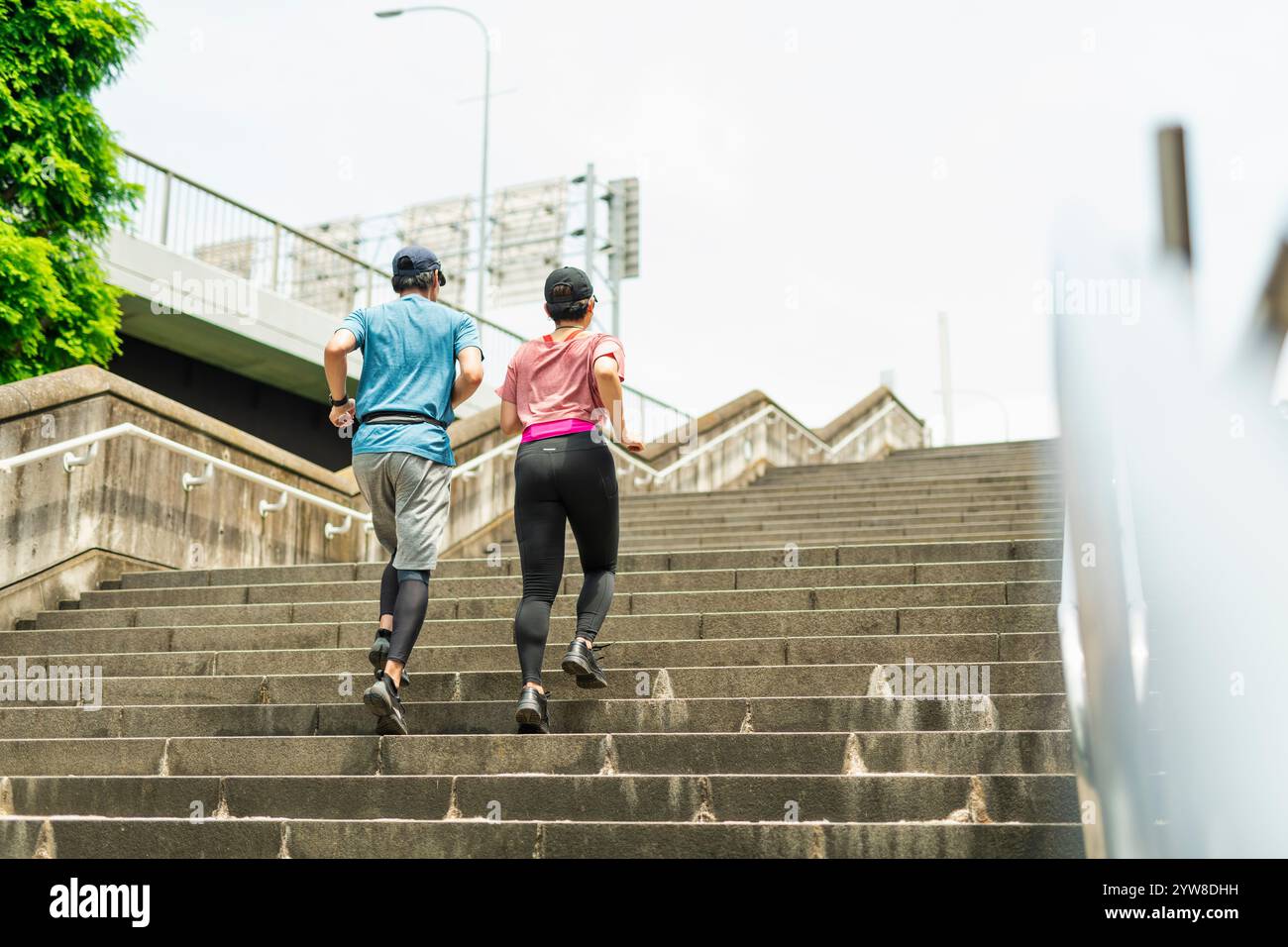 Man and woman running up stairs Stock Photo - Alamy
