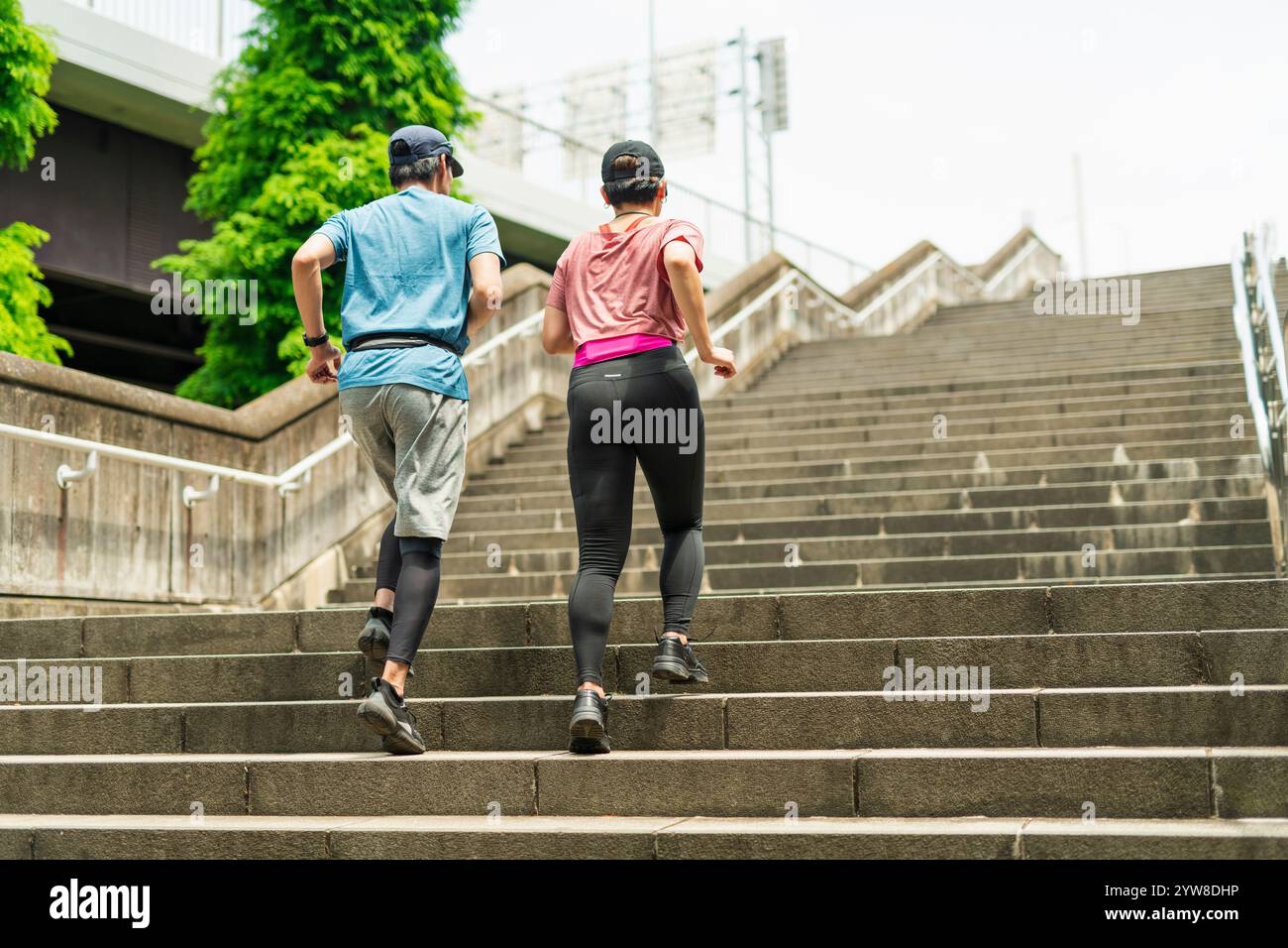 Two women running up stairs hi-res stock photography and images - Alamy