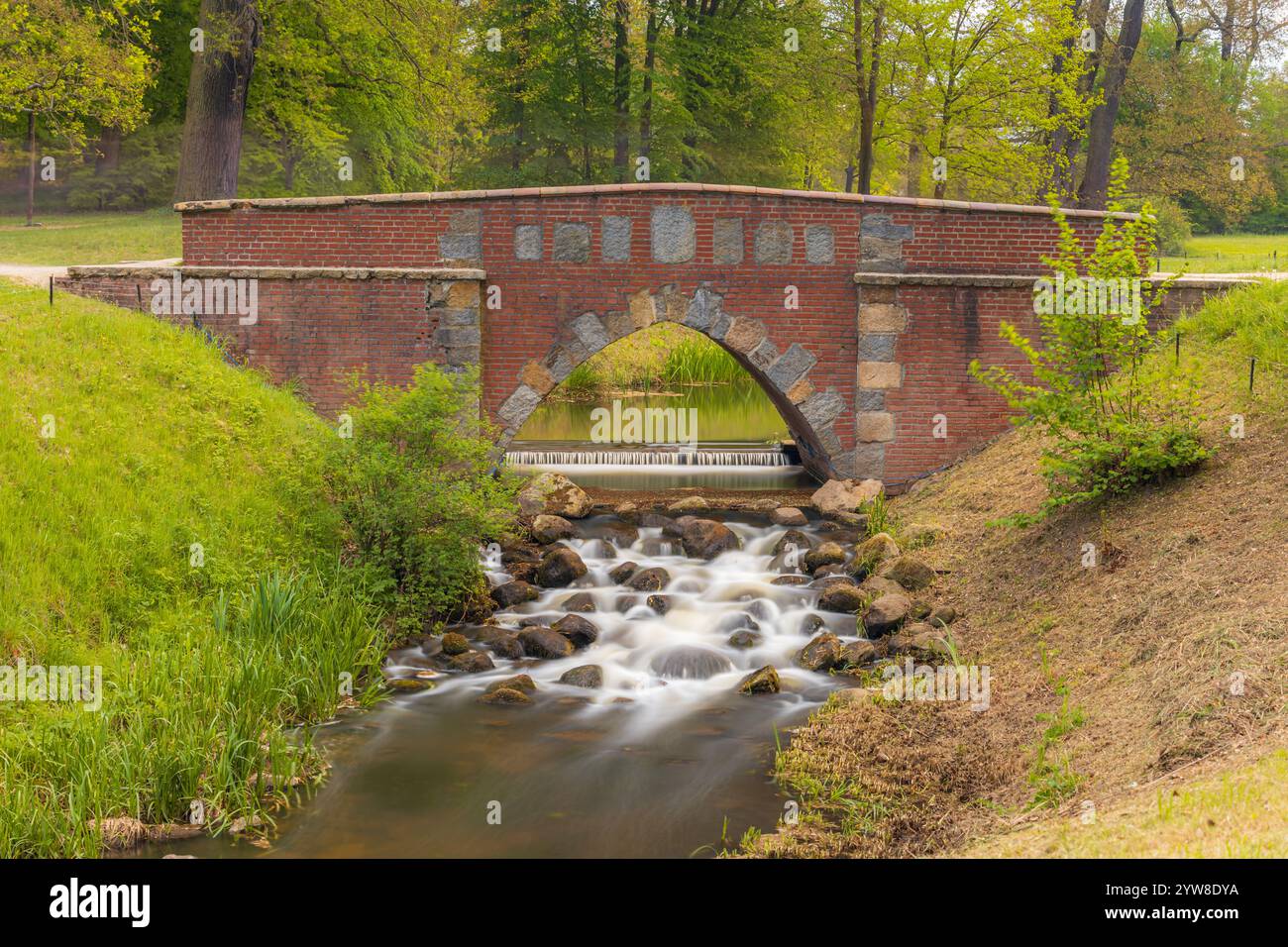Serene Cascading Stream Flowing Through Scenic Stone Arch Bridge Stock ...