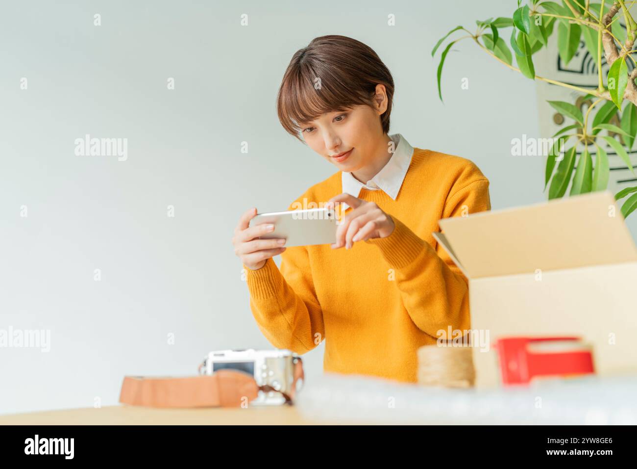 Woman taking photos of merchandise Stock Photo - Alamy