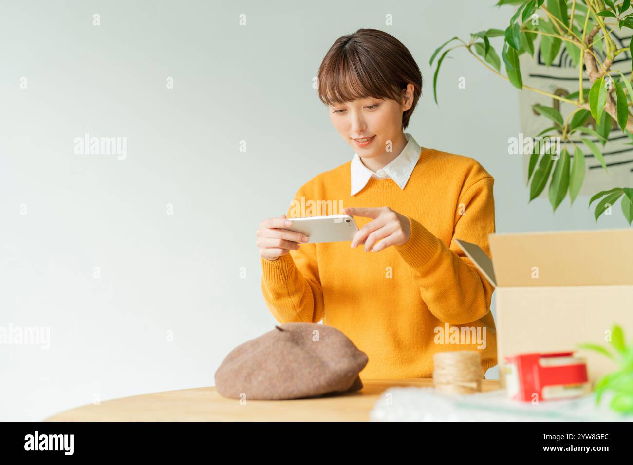 Woman taking photos of merchandise Stock Photo - Alamy