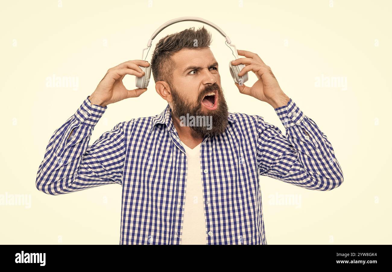 Millennial hipster man listen to music in headphones. Loud music. Man ...