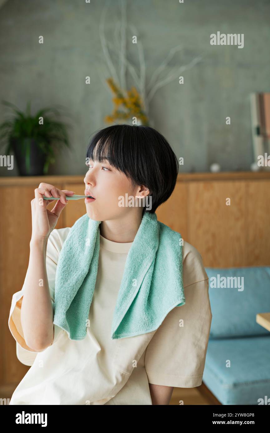 Woman brushing her teeth after bathing Stock Photo - Alamy