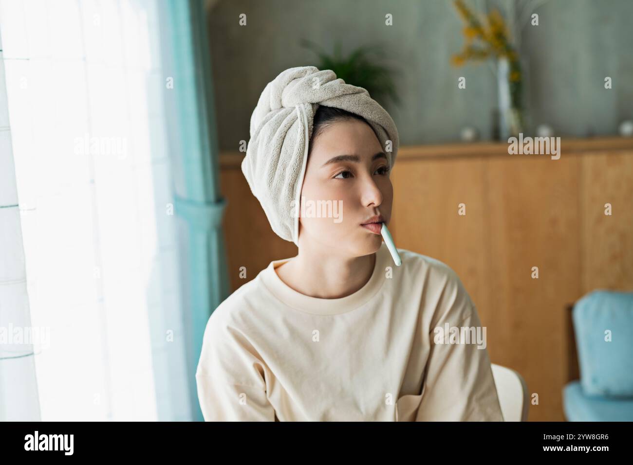 Woman brushing her teeth after bathing Stock Photo - Alamy
