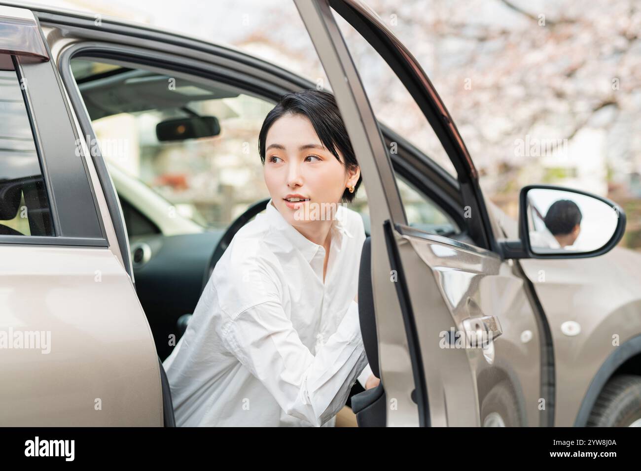 Woman getting out of car Stock Photo - Alamy