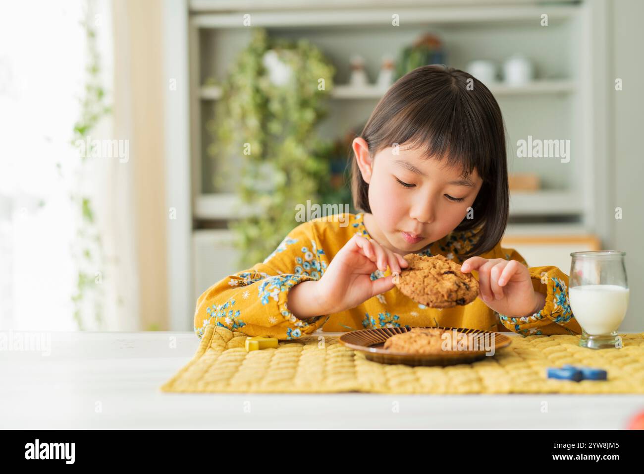 Girl eating a snack Stock Photo - Alamy