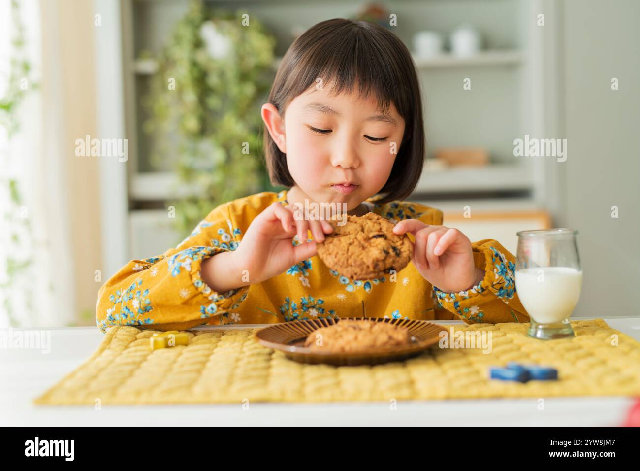 Girl eating a snack Stock Photo - Alamy