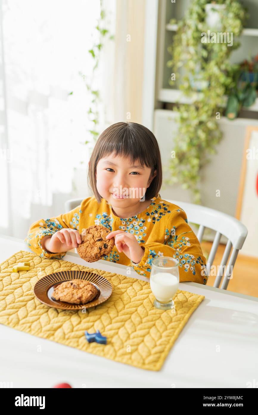 Girl eating a snack Stock Photo - Alamy