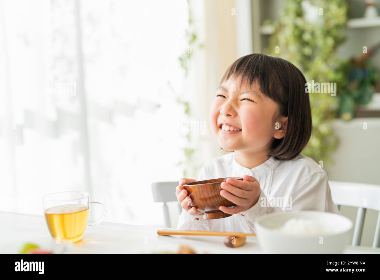 Girl eating breakfast Stock Photo - Alamy
