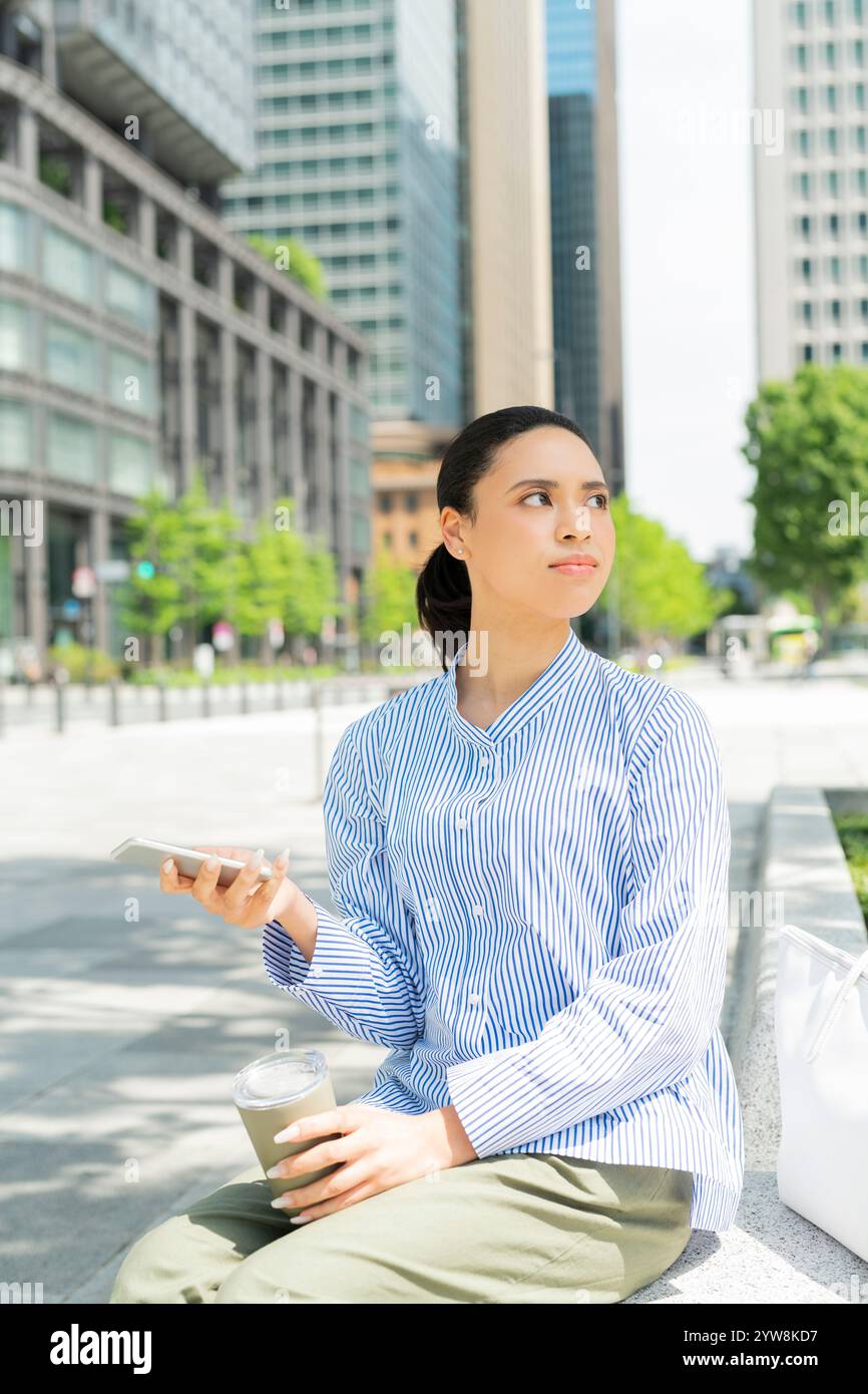 Half-women waiting in front of station Stock Photo - Alamy