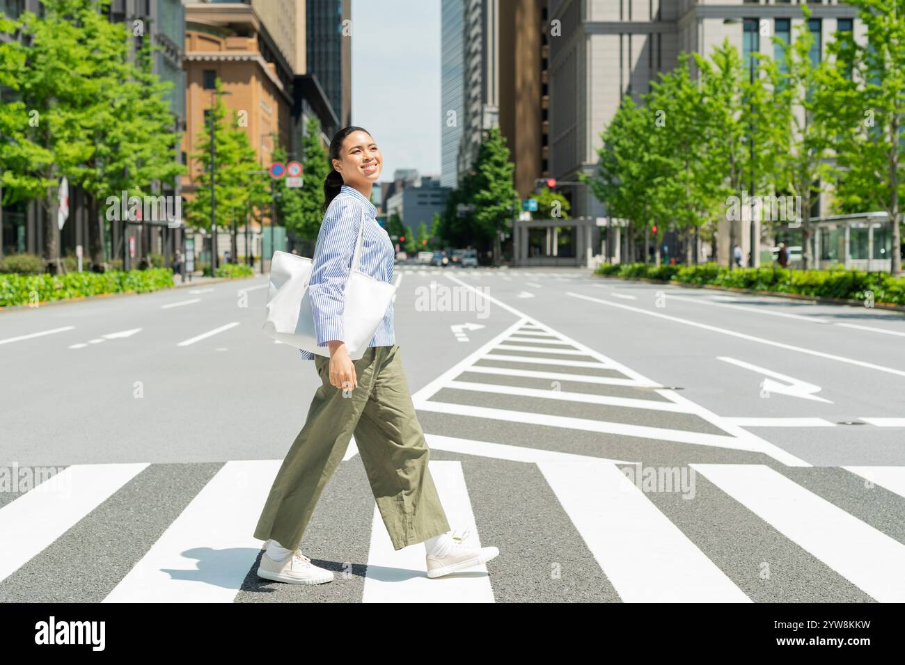 Half-woman crossing the pedestrian crossing Stock Photo - Alamy