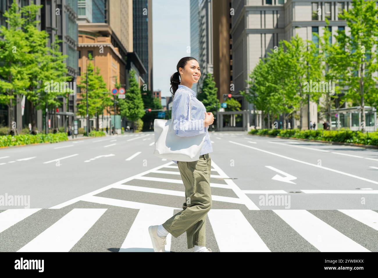 Half-woman crossing the pedestrian crossing Stock Photo - Alamy