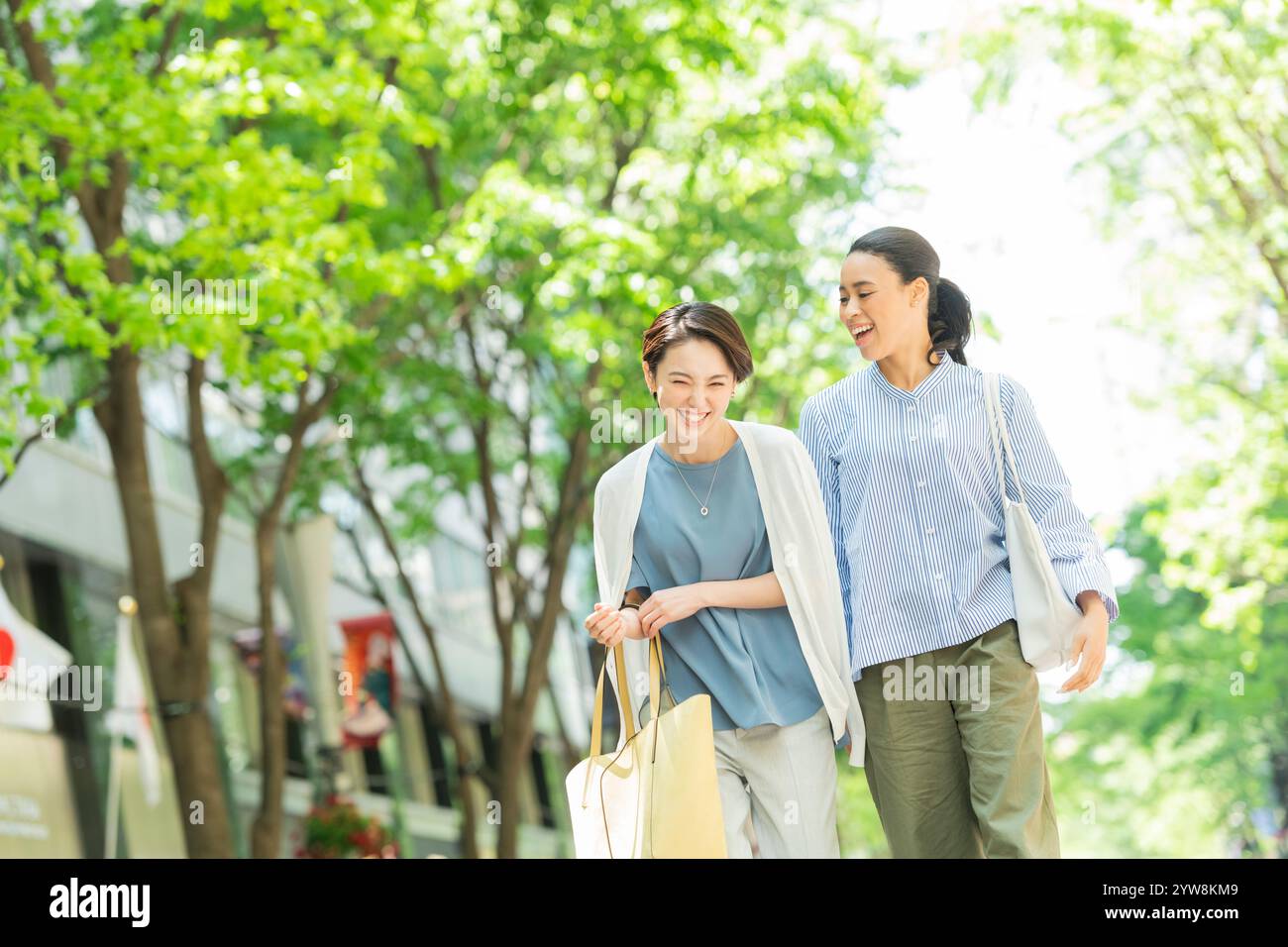Two women walking in the street Stock Photo - Alamy