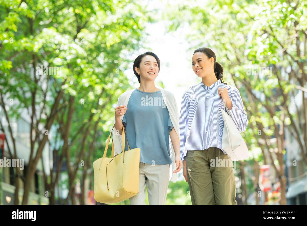 Two women walking in the street Stock Photo - Alamy