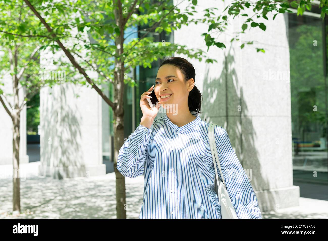 Half woman making a phone call in an office block Stock Photo - Alamy