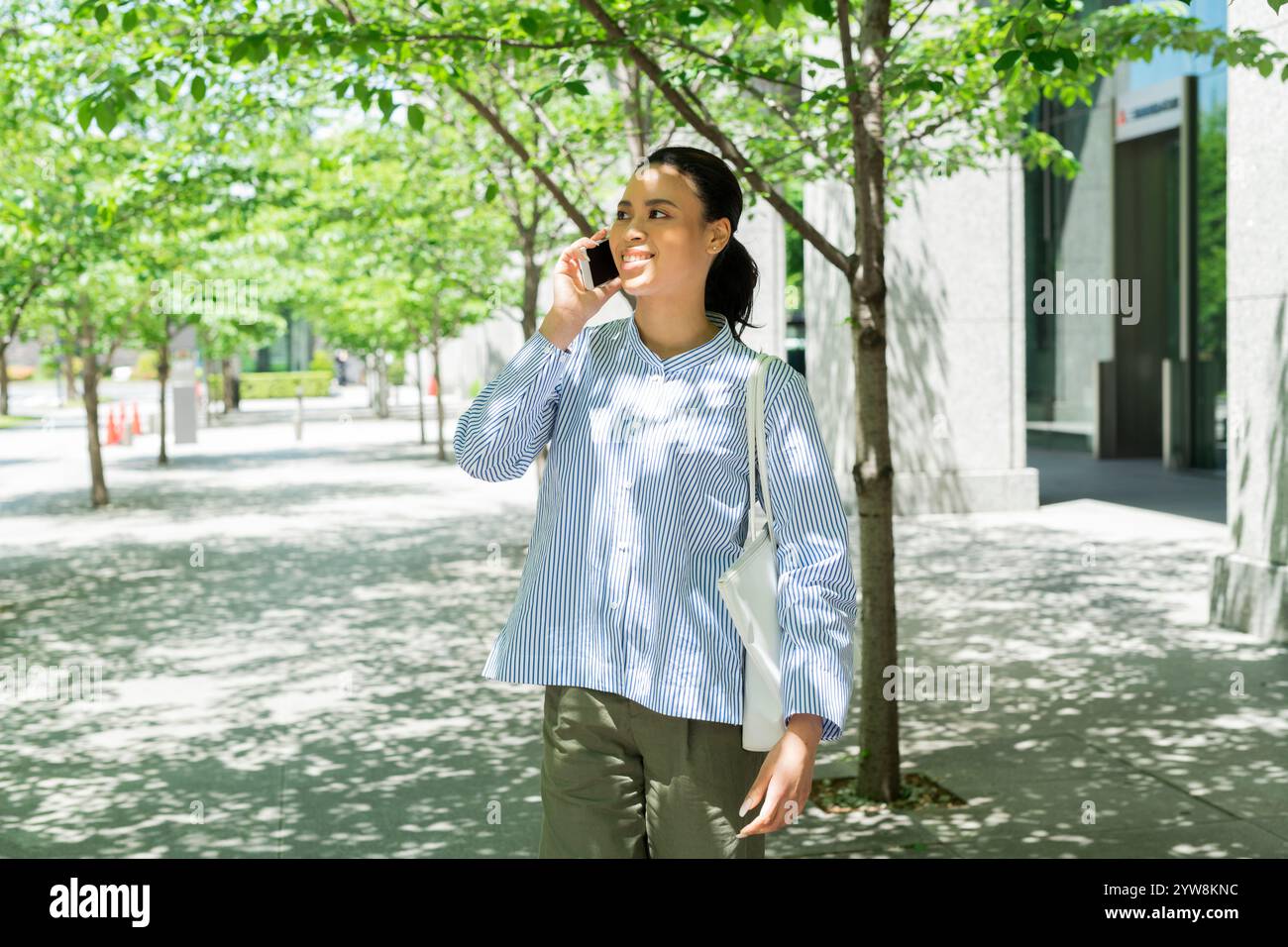 Half woman making a phone call in an office block Stock Photo - Alamy