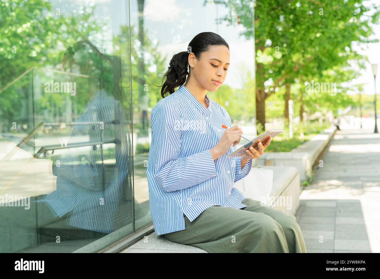 Half woman operating a tablet device outdoors Stock Photo - Alamy
