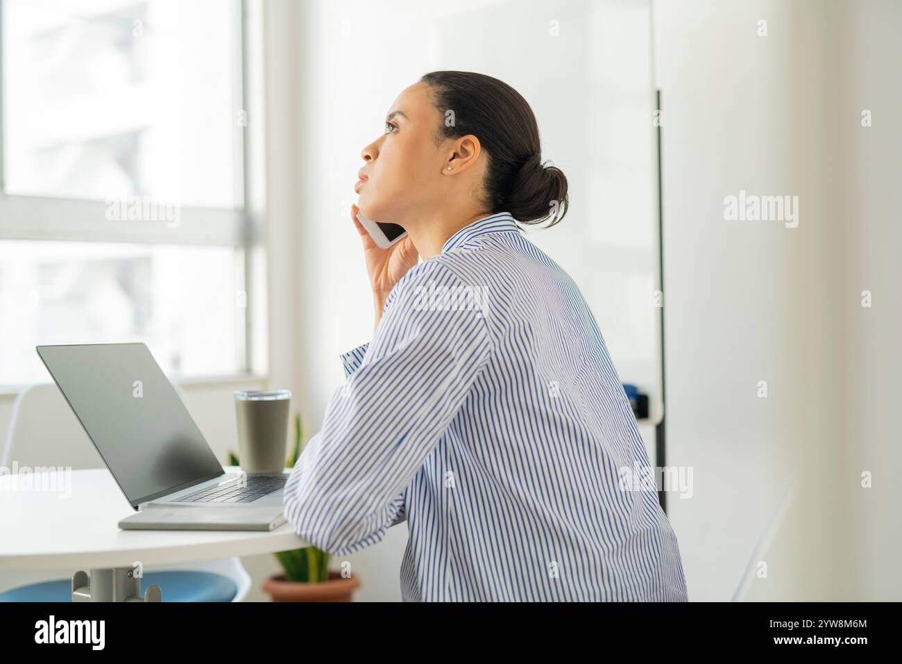 Woman making personal call in office hi-res stock photography and ...