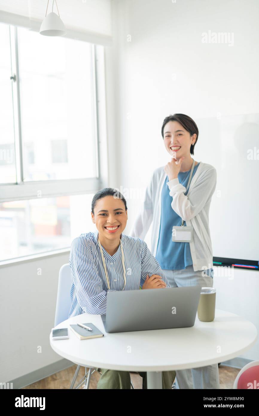 Two women in office Stock Photo - Alamy