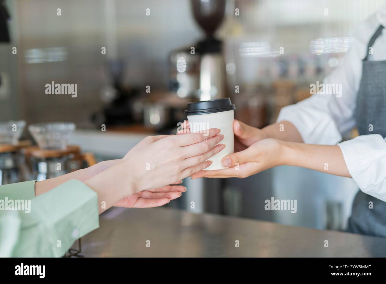Café Female staff handing over products Stock Photo - Alamy