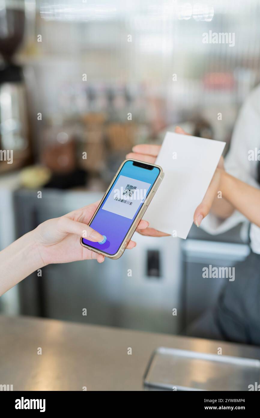 Café Woman reading QR code Stock Photo - Alamy