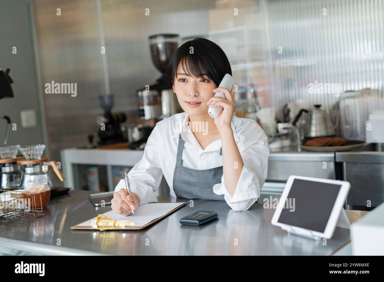 Café Female staff making a phone call Stock Photo - Alamy