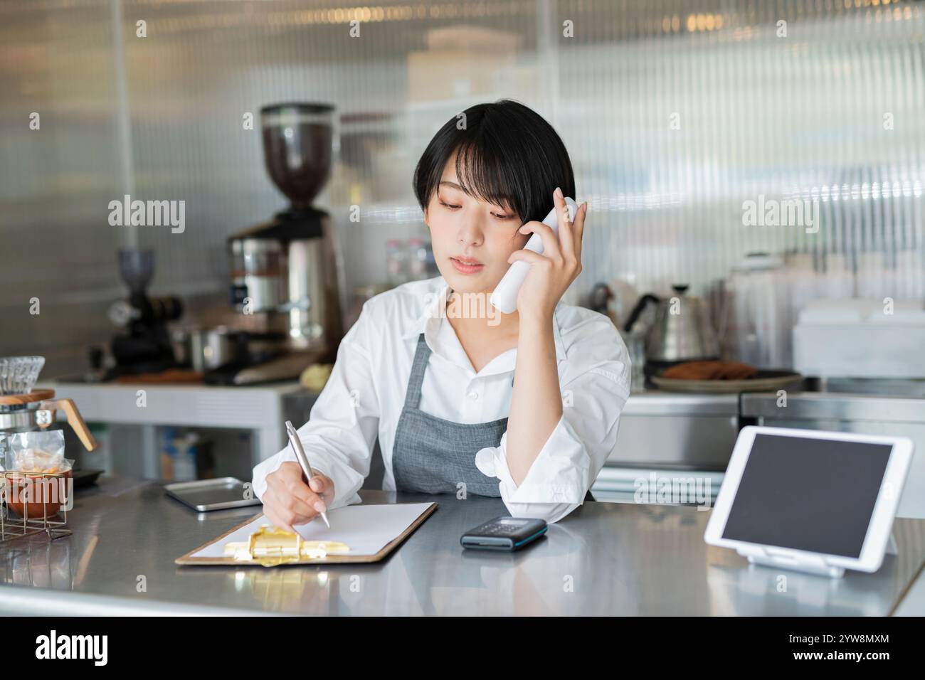 Café Female staff making a phone call Stock Photo - Alamy