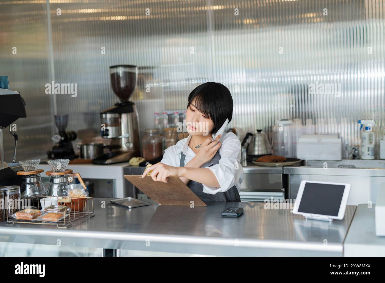Café Female staff making a phone call Stock Photo - Alamy