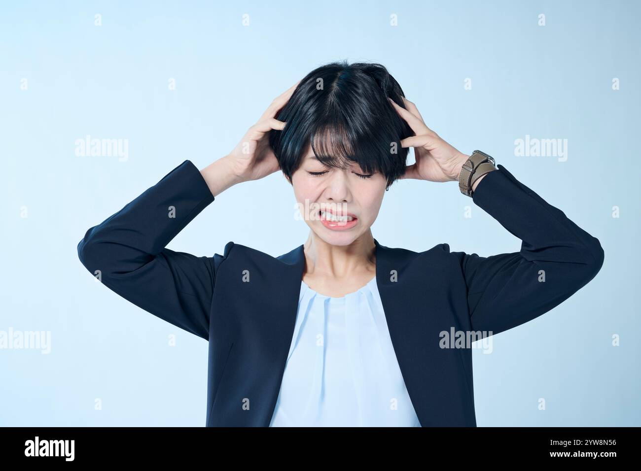 Female office worker with short hair thinking Stock Photo - Alamy
