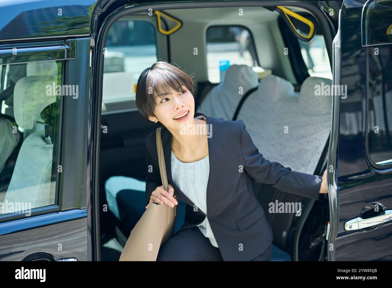 Woman getting out taxi hi-res stock photography and images - Alamy