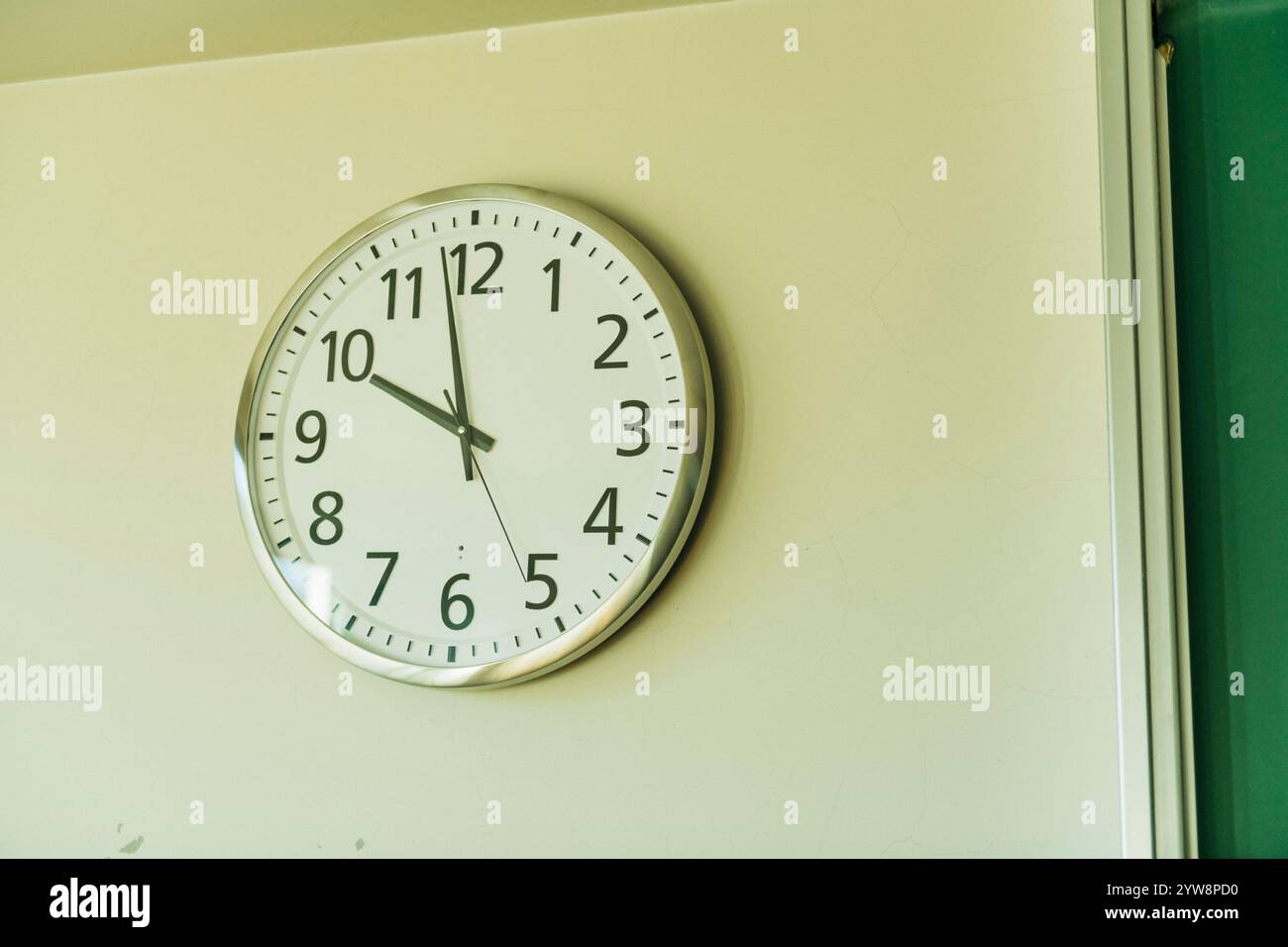 Clock in classroom Stock Photo - Alamy