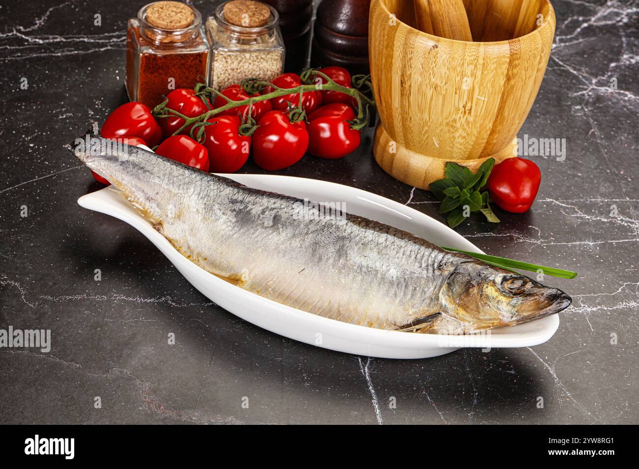 Whole raw salted herring fish in the plate Stock Photo - Alamy
