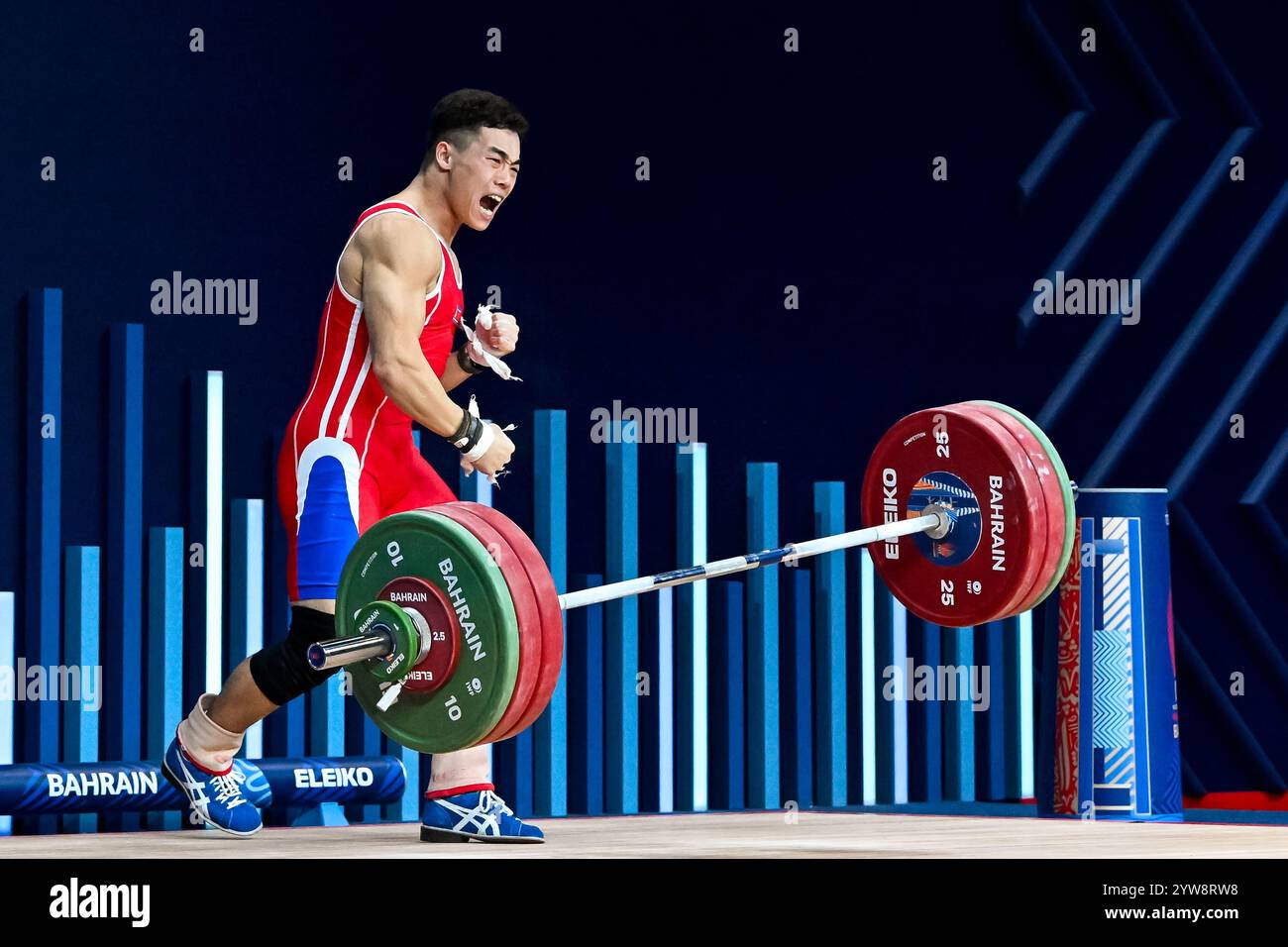 Ryong Hyon Ri of North Korea reacts after competing in clean & jerk, in ...