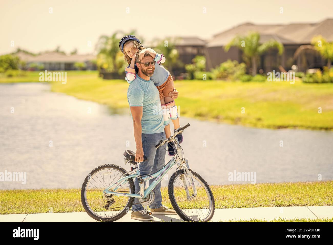 happy son and daddy cycling on bicycle. Nurturing family connections ...