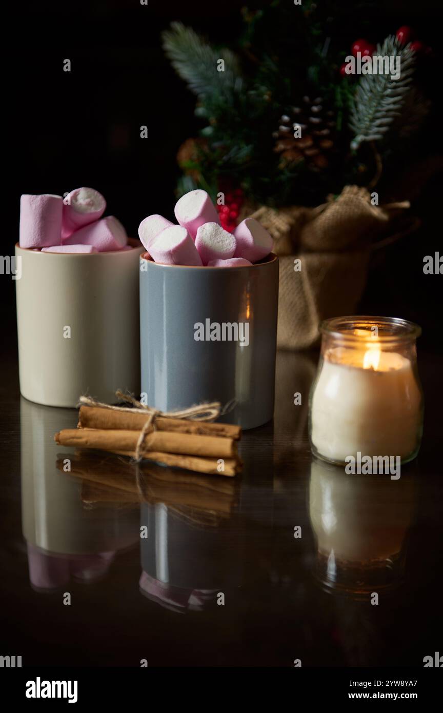 Warm and inviting winter setup featuring mugs with marshmallows ...