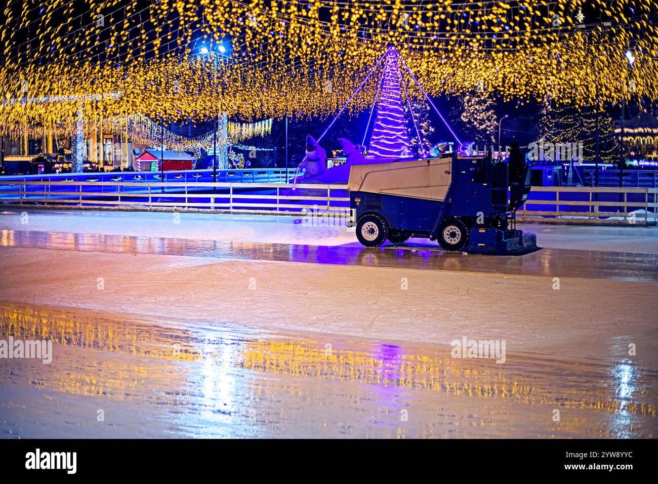 machine on a festive figure skating rink polishes the ice after skating ...