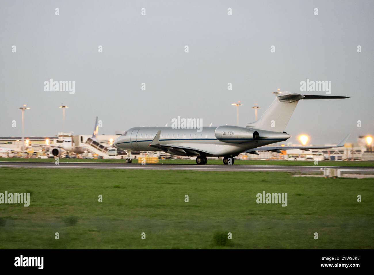 Silver private jet taxiing on the runway at lisbon airport, ready for ...