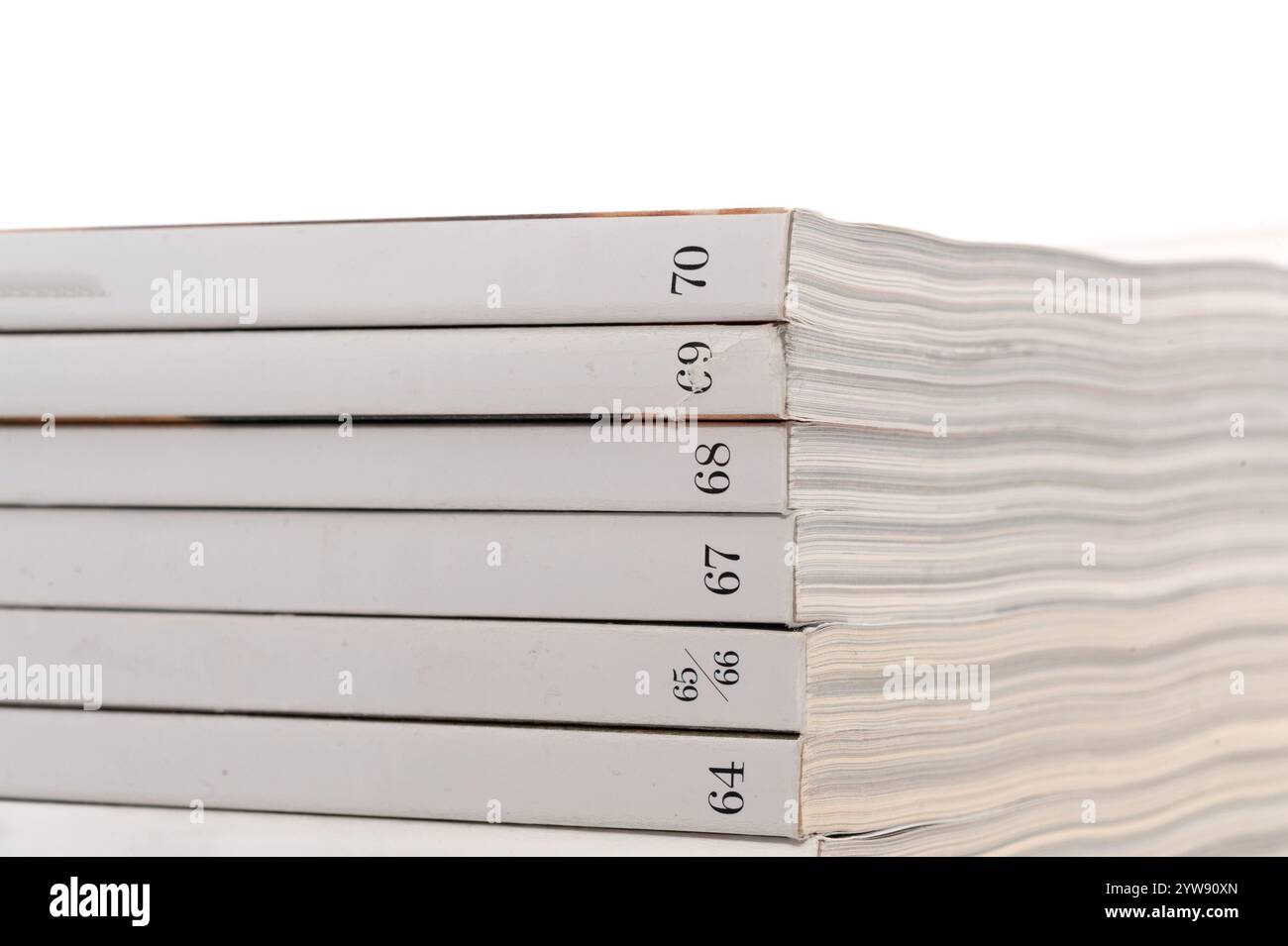 A stack of books with the numbers 65 through 74 on the spine. The books ...