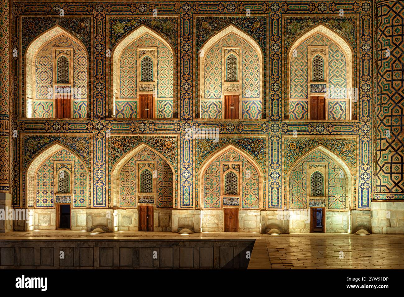 Night view of colorful arched niches of the Tilya-Kori Madrasah Stock ...
