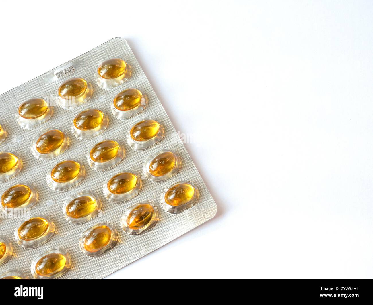golden pills Medicine tablet capsules in blister pack on a white ...