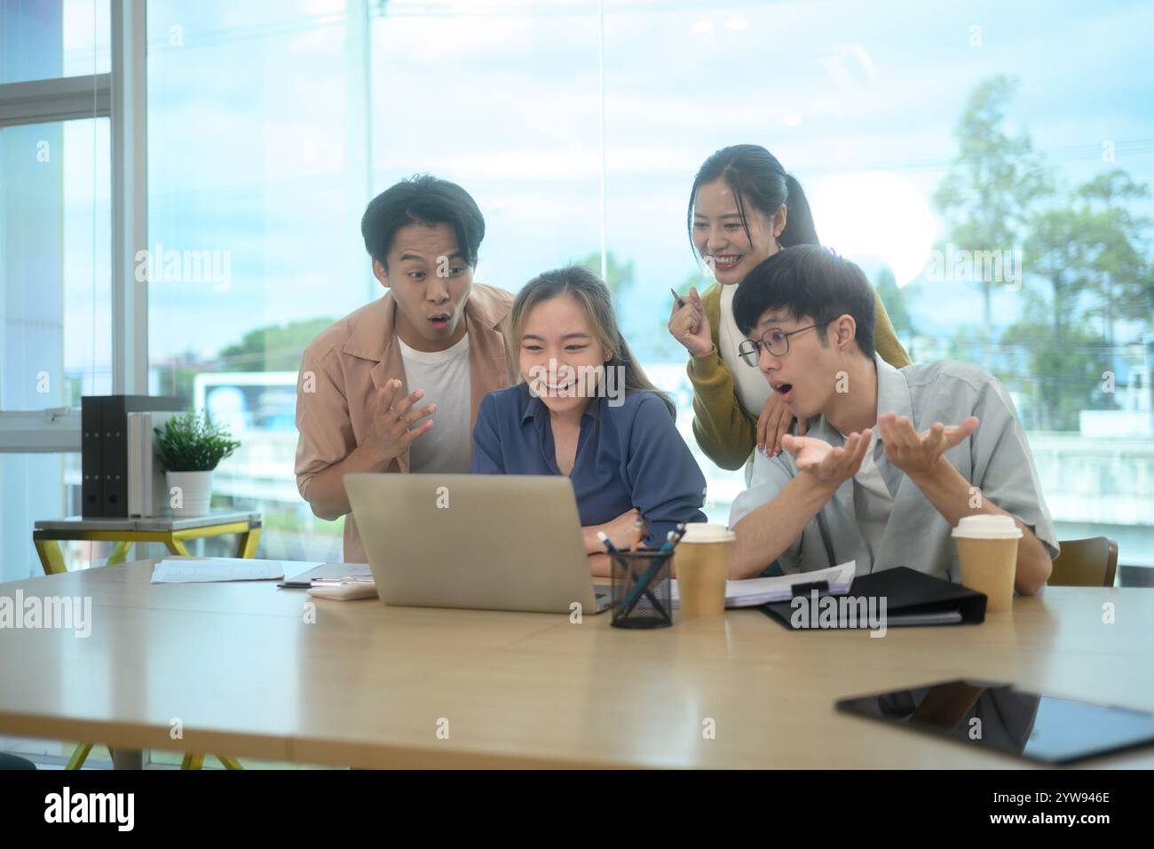 Group of young start up businesspeople celebrating breakthrough or ...