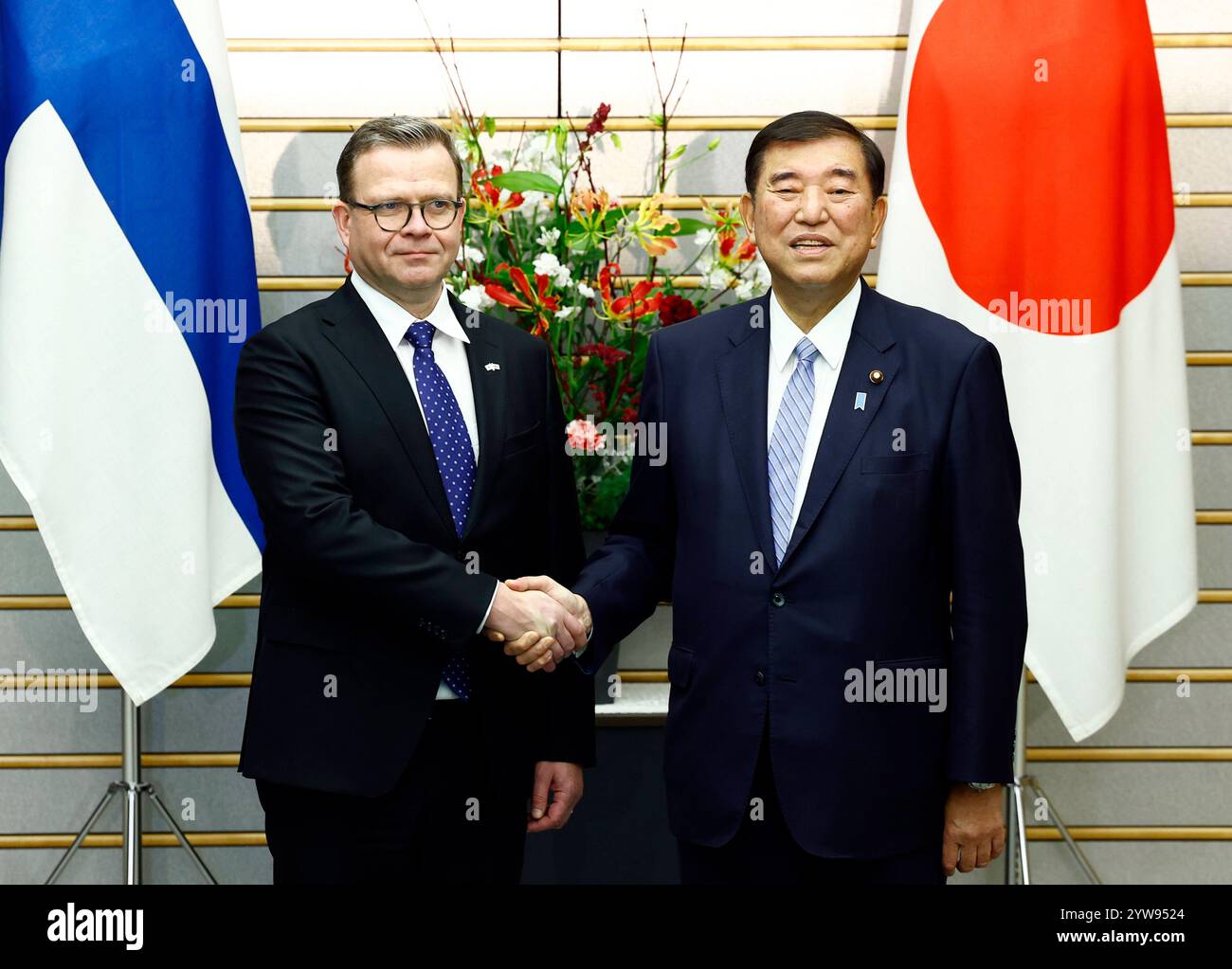 Finland Prime Minister Petteri Orpo, left, shakes hands with Japan's ...
